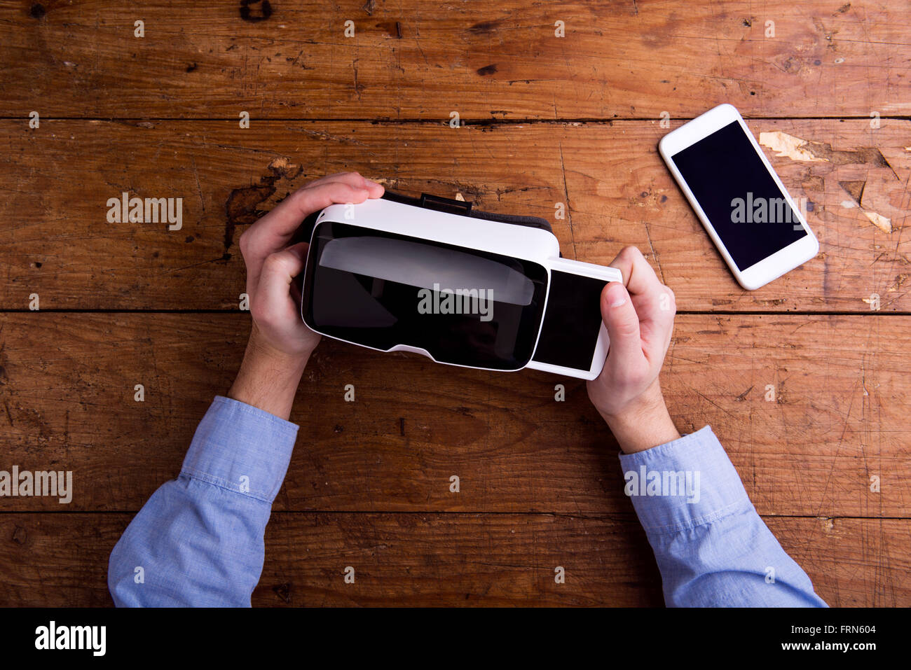 Hands of man holding virtual reality goggles and smartphone Stock Photo ...