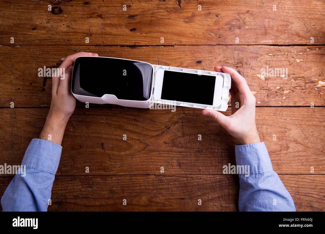 Hands of man holding virtual reality goggles and smartphone Stock Photo ...