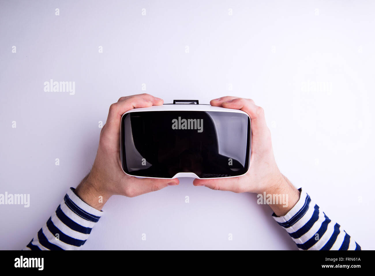 Hands of man holding virtual reality goggles. Flat lay Stock Photo - Alamy
