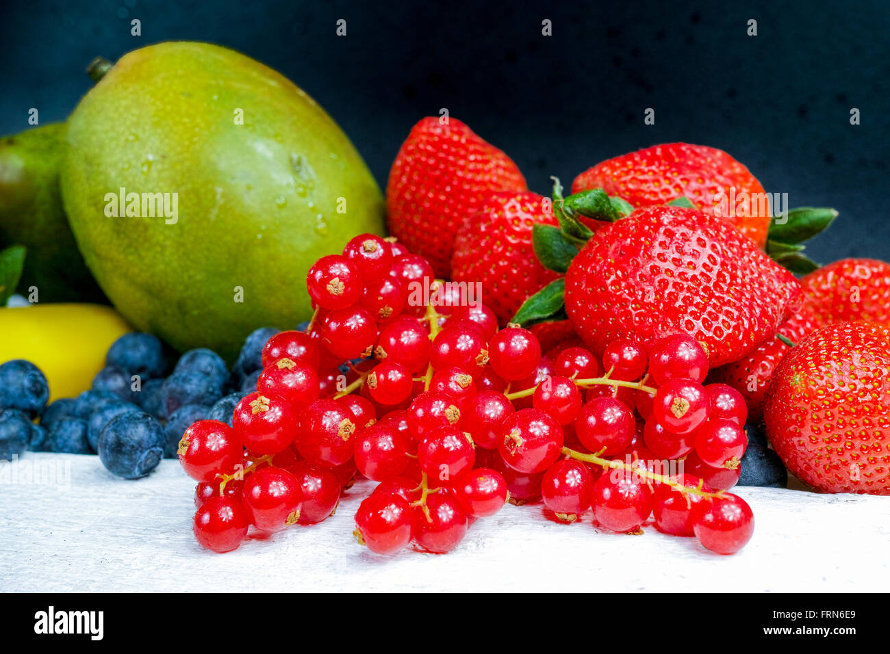 Variety fresh organic red and blue berry, strawberry, mango and green ...