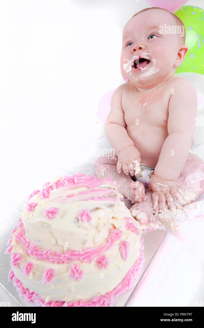 A baby smashing and eating a birthday cake Stock Photo - Alamy