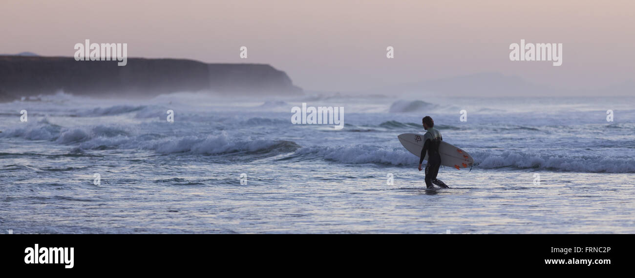 Surfers on beach with surfboard Stock Photo - Alamy