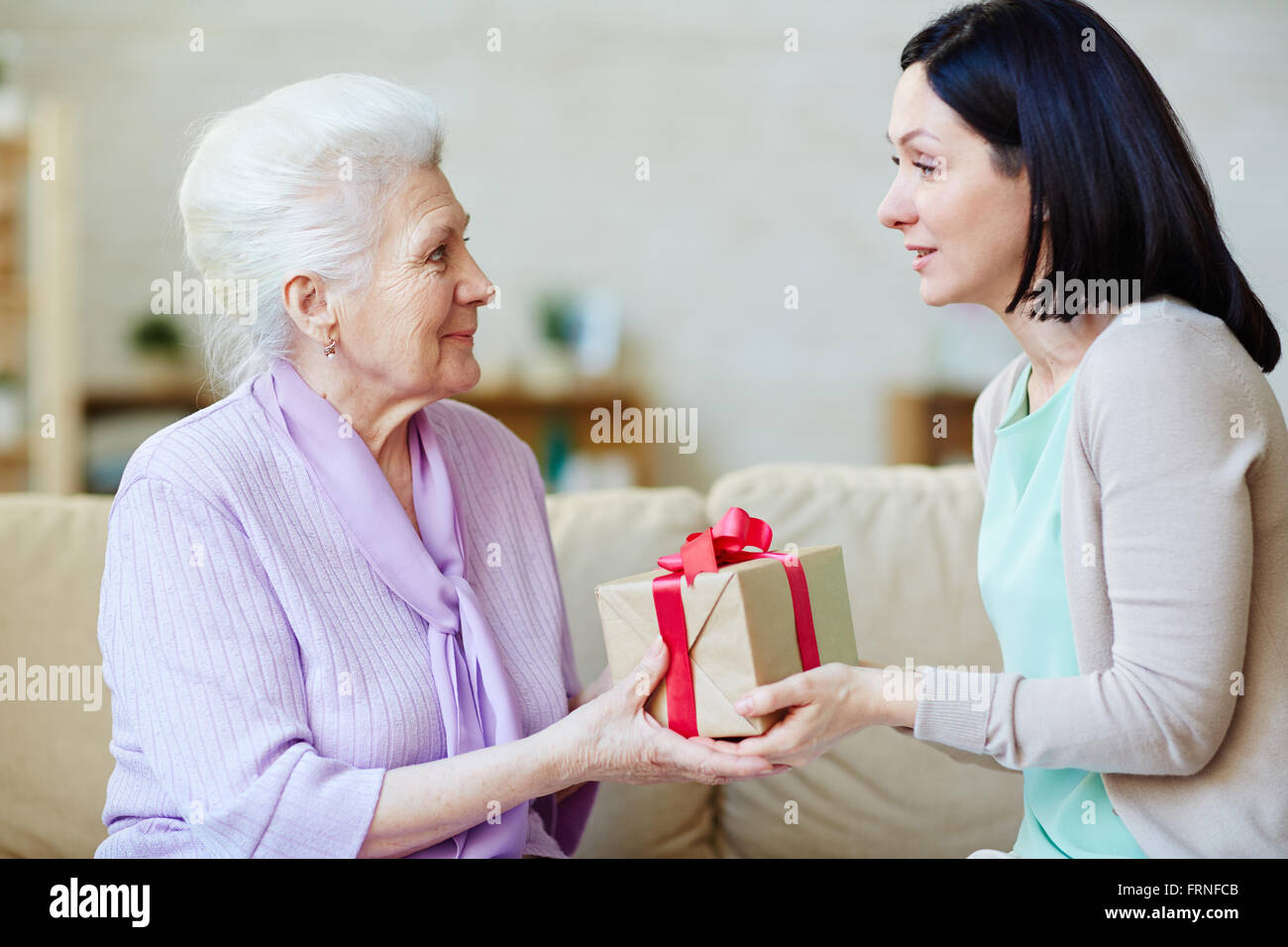 Woman giving present mother hi-res stock photography and images - Alamy