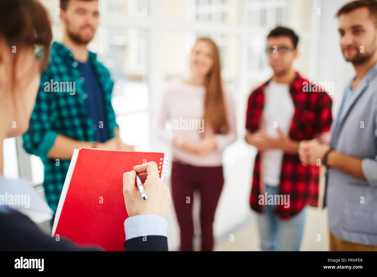 Teacher with notepad and pen Stock Photo - Alamy
