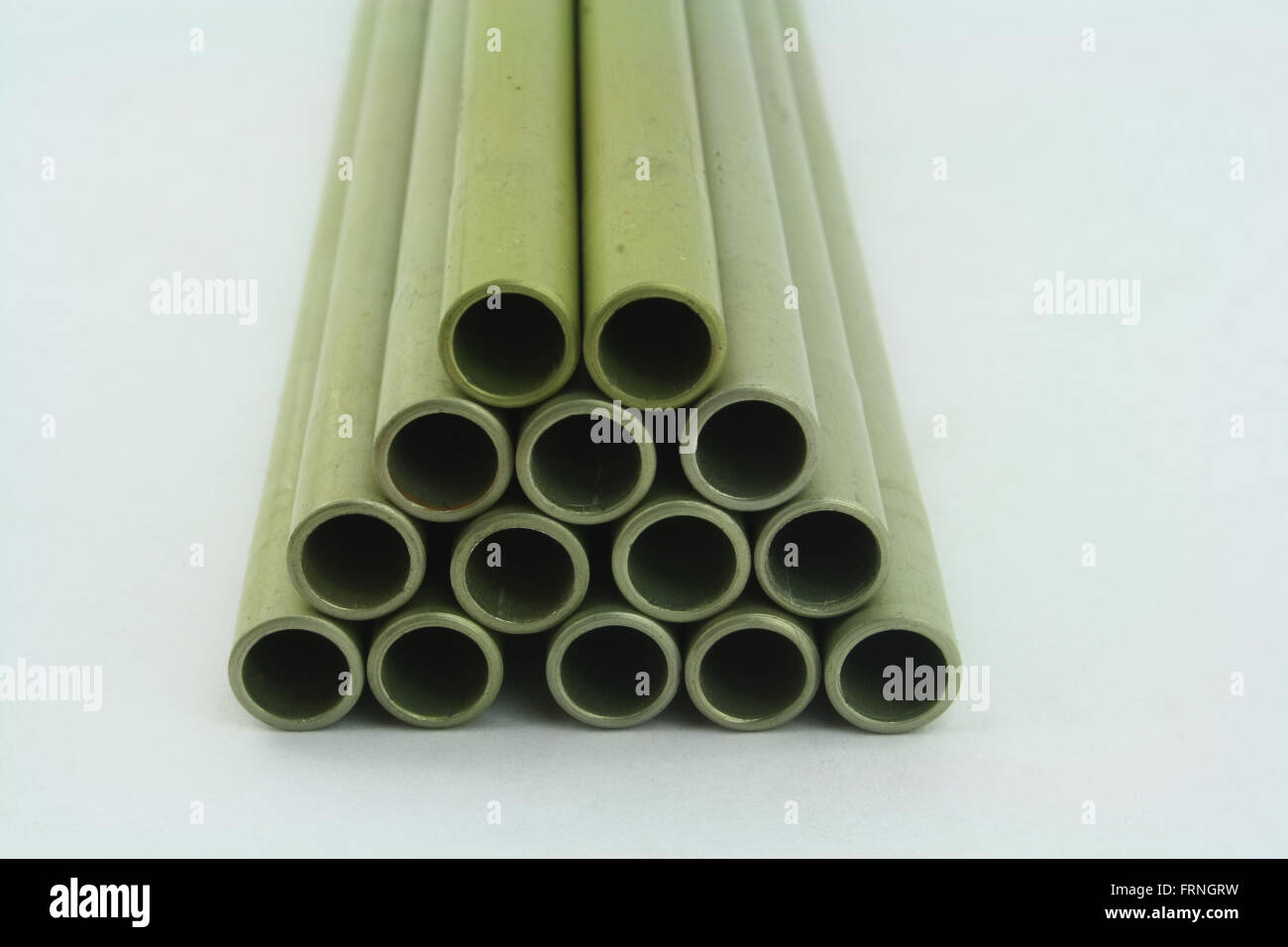 stack of green aluminum tubes Stock Photo - Alamy