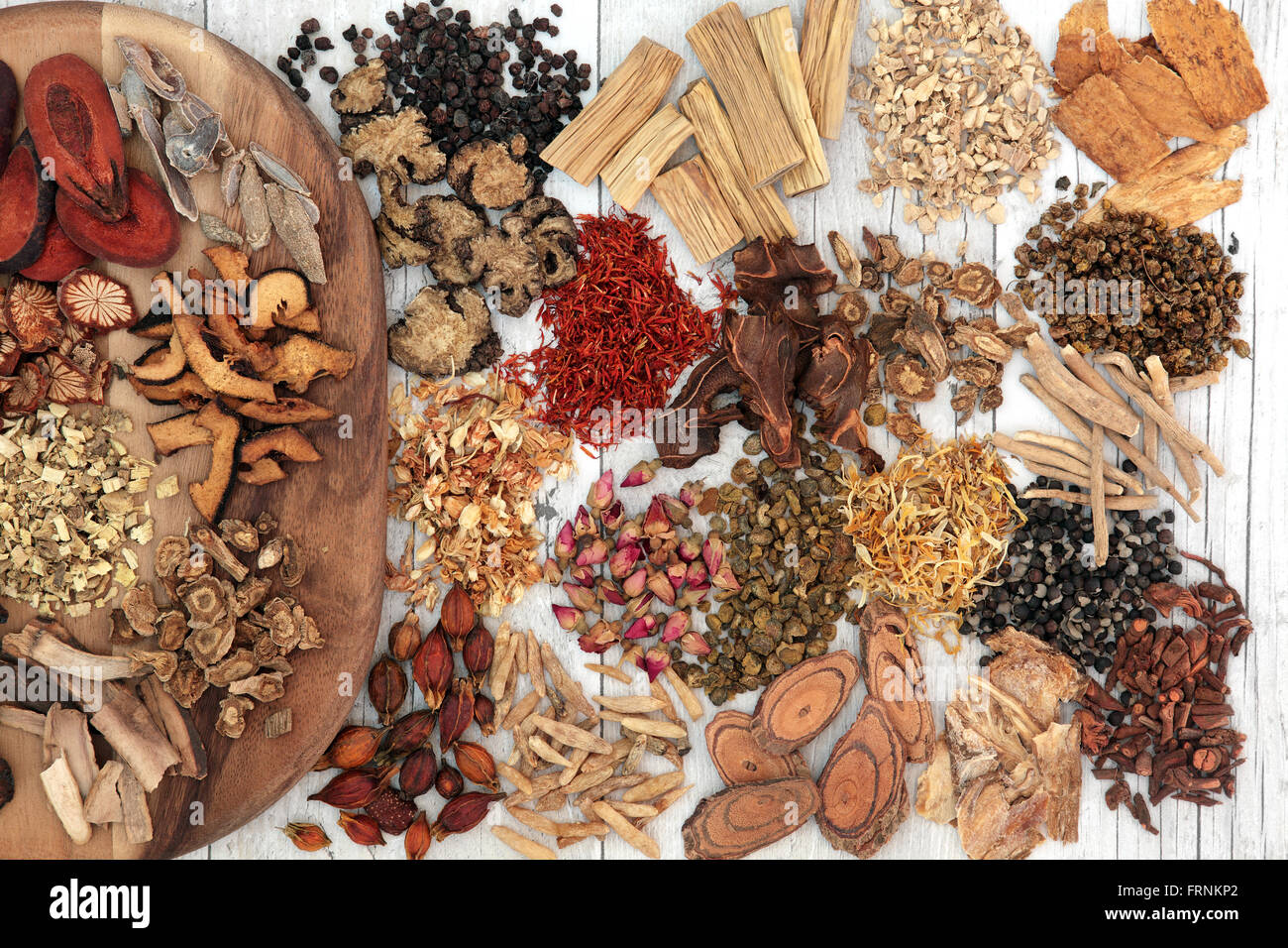 Traditional chinese herbal medicine ingredients on a maple wood board ...