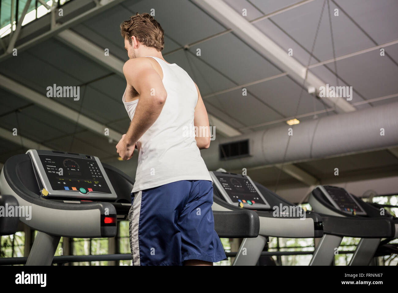 Man running on thread mill Stock Photo - Alamy