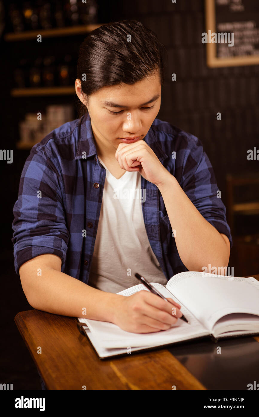 Hipster man writing on planner Stock Photo - Alamy