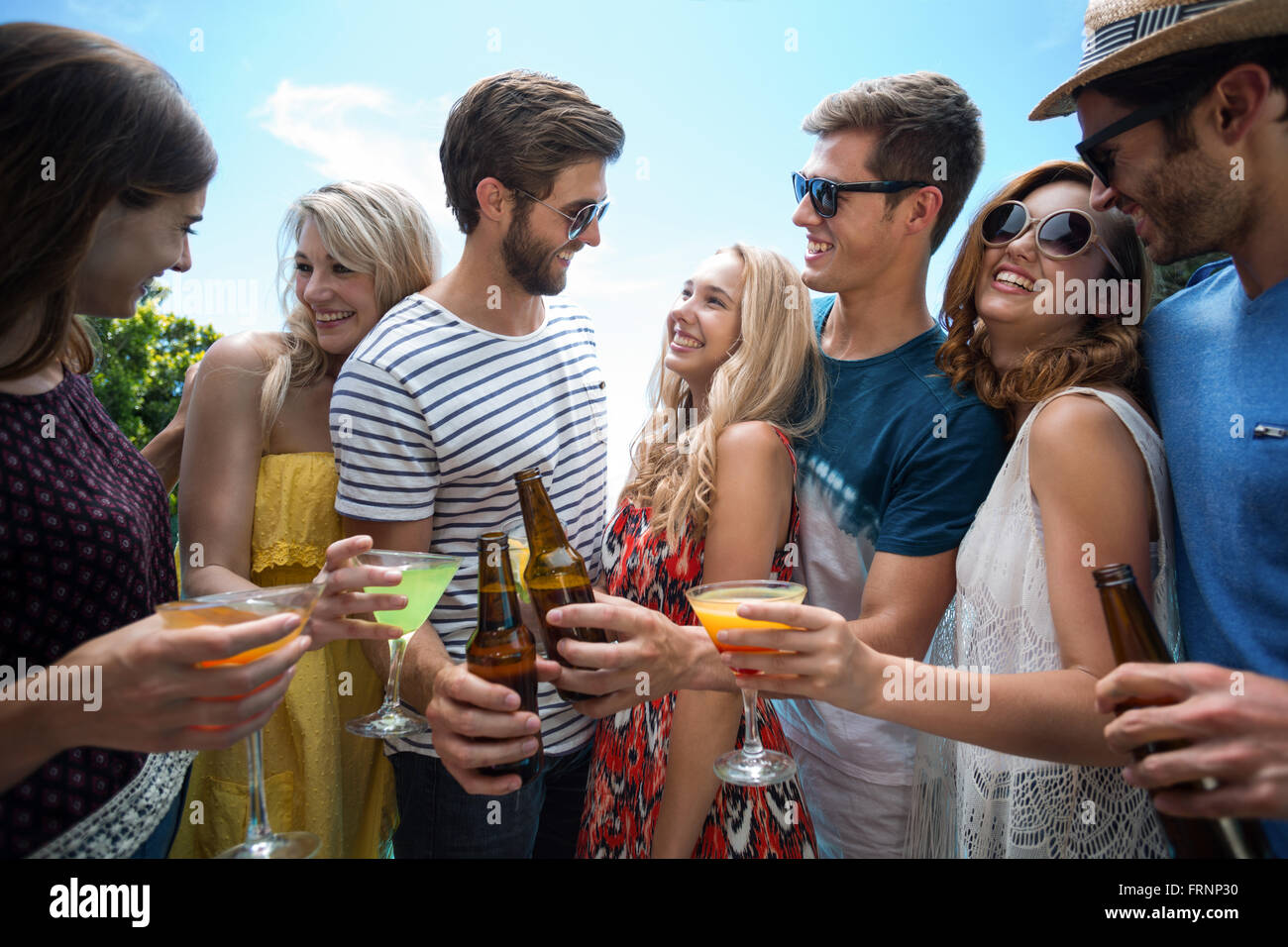 Happy couple enjoying with their friends Stock Photo - Alamy
