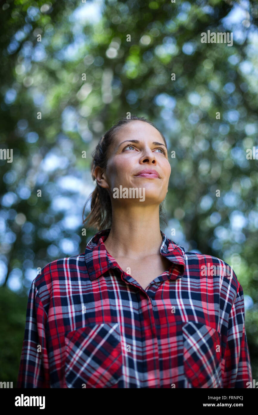 Thoughtful young woman looking up Stock Photo - Alamy