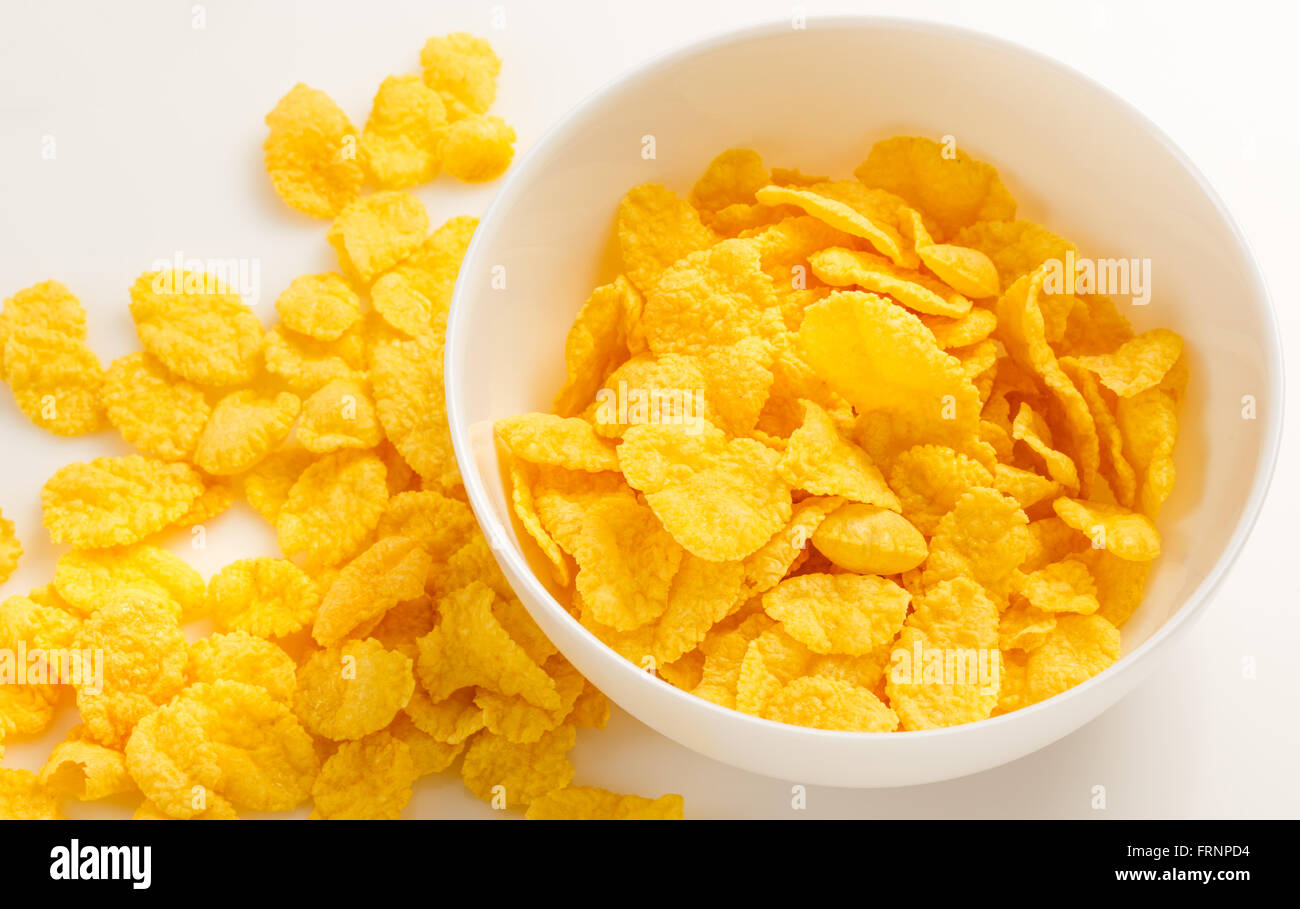 Yellow corn flakes in the white bowl Stock Photo - Alamy