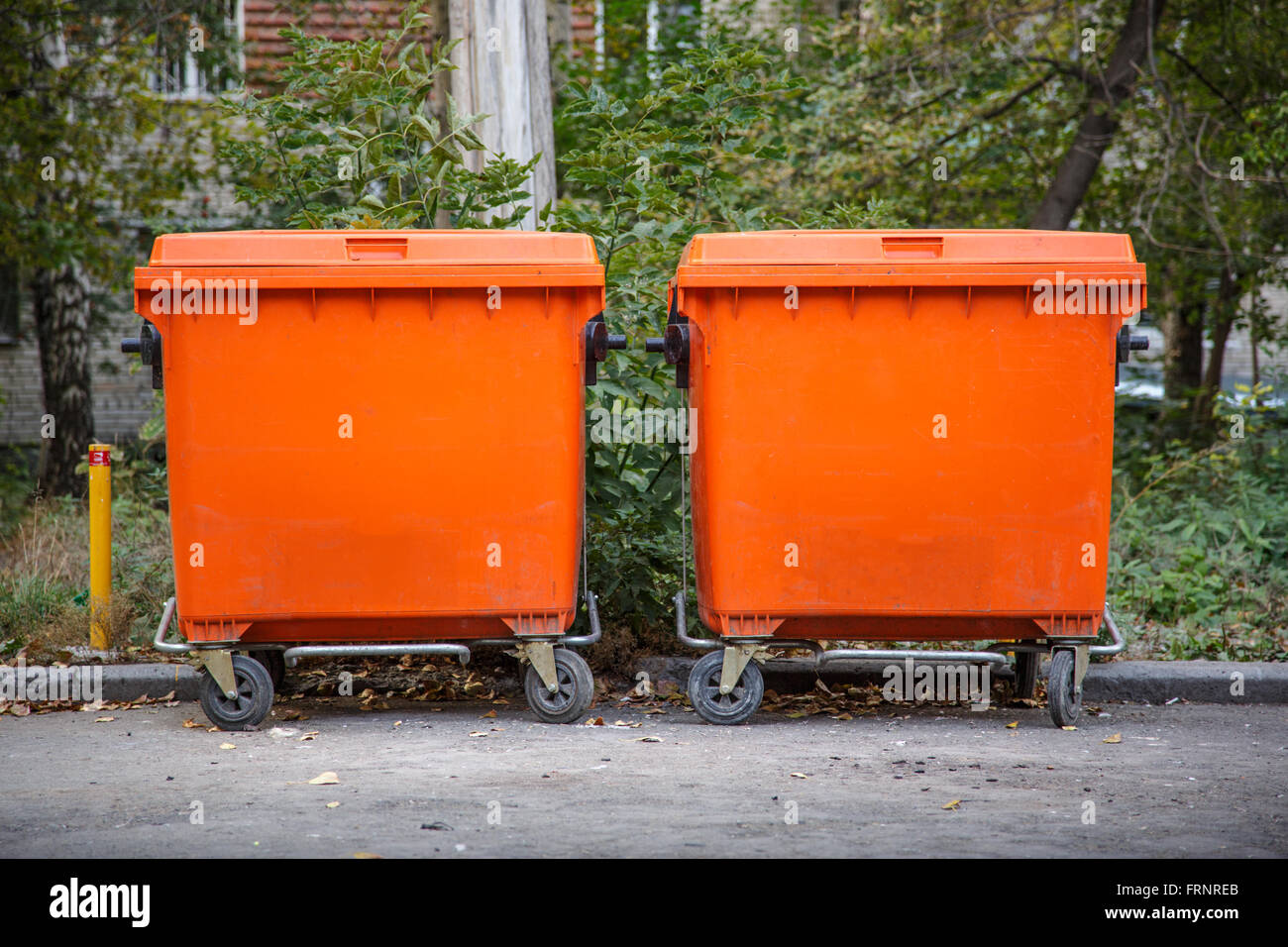 Photo of two orange garbage bins outside Stock Photo - Alamy