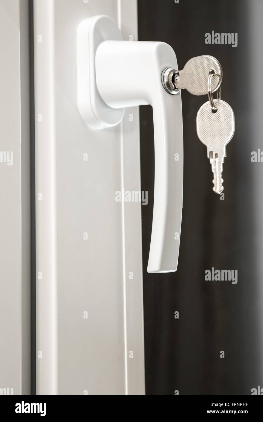 Handle plastic windows with keys in closeup Stock Photo - Alamy