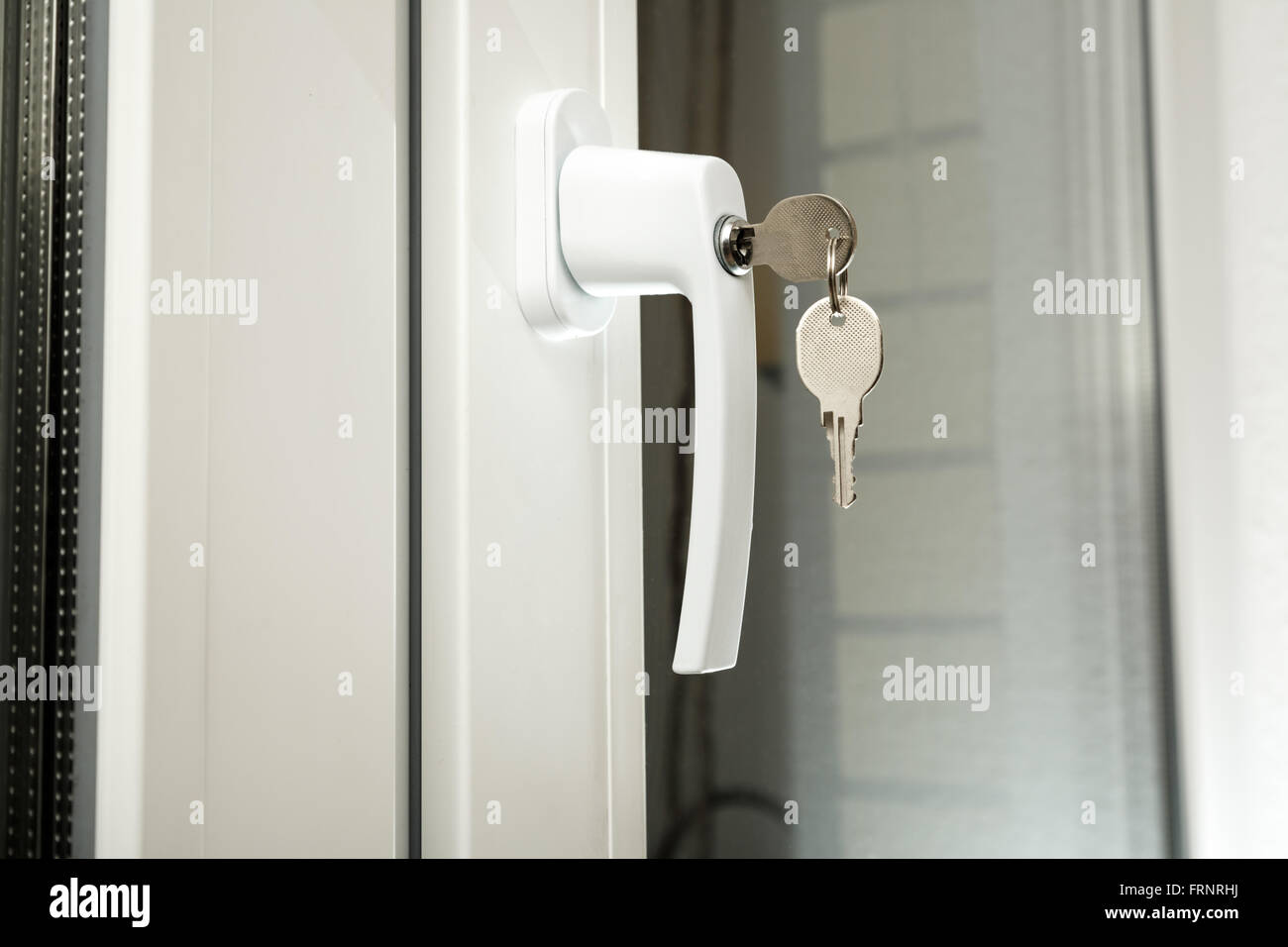 Handle plastic windows with keys in closeup Stock Photo - Alamy