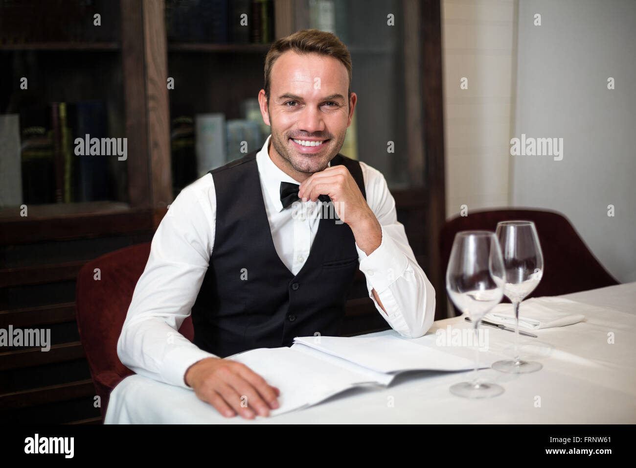 Portrait of waiter reading the menu Stock Photo - Alamy
