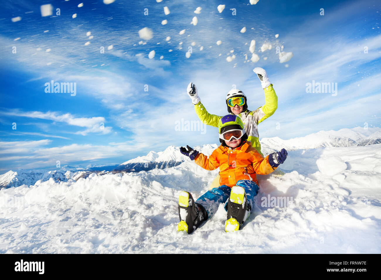 Mother and son on the mountain happy throw snow Stock Photo - Alamy