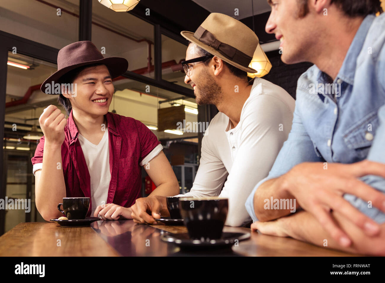 Friends sitting at a table Stock Photo - Alamy