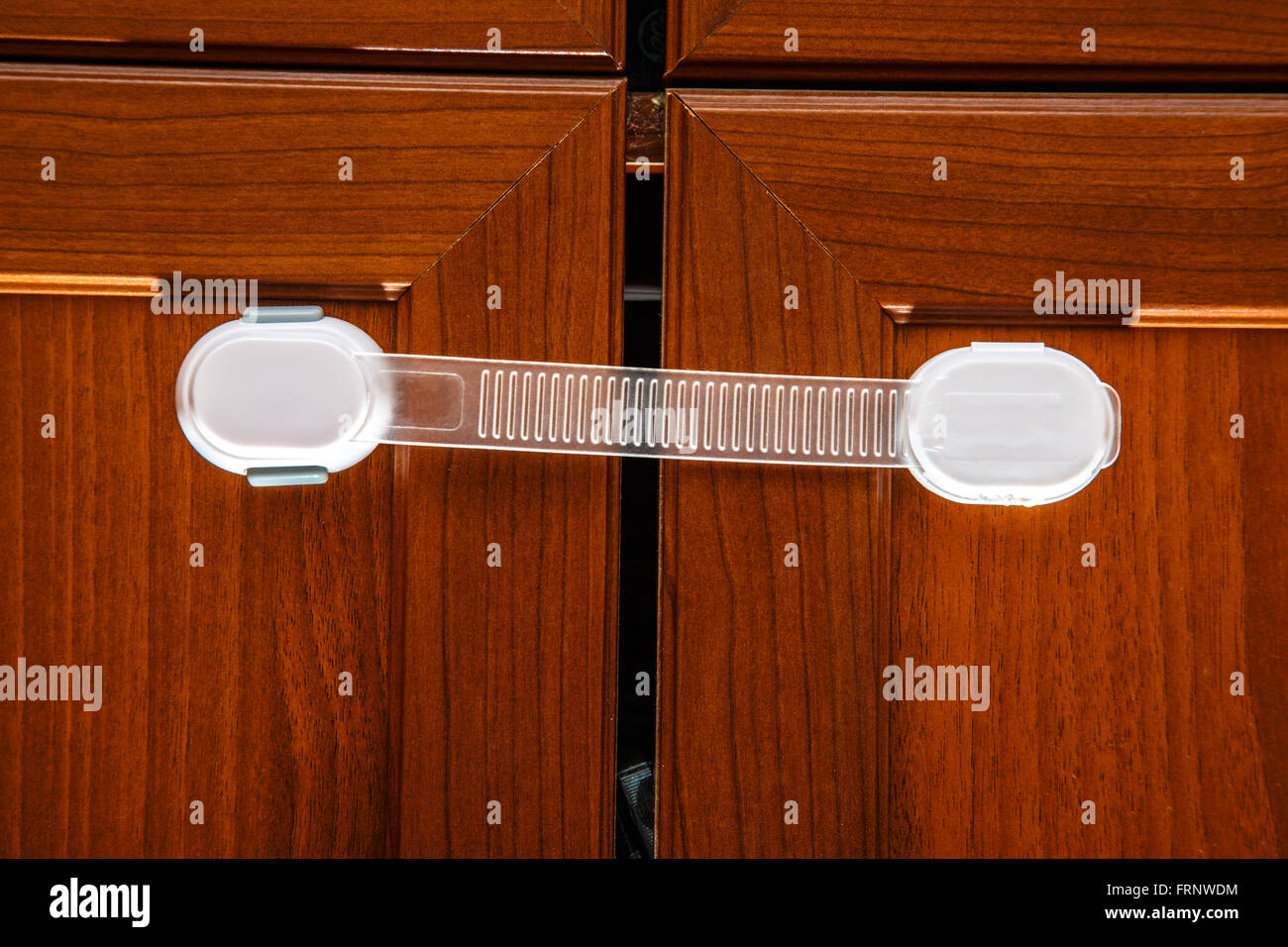 Safety plastic lock for kid protection on wardrobe Stock Photo - Alamy