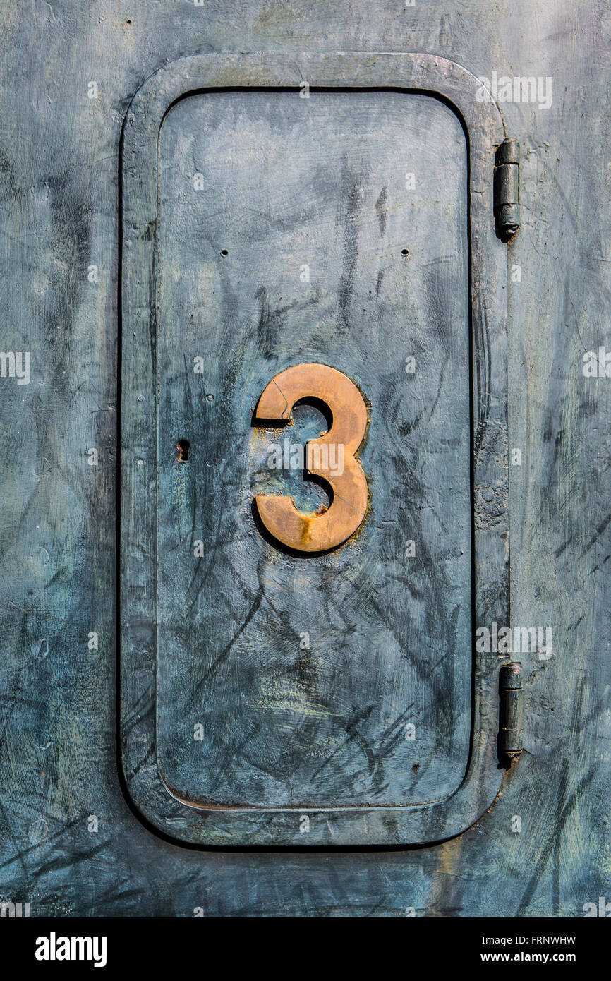 A brass number 3 on an old railway engine Stock Photo - Alamy