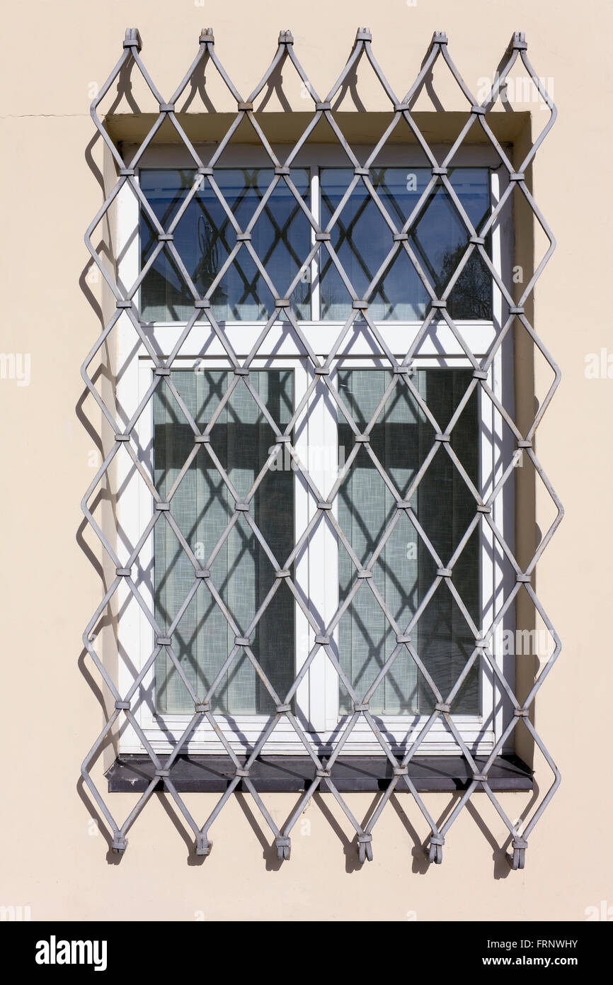 The gray steel lattice protects a window on the first floor from ...