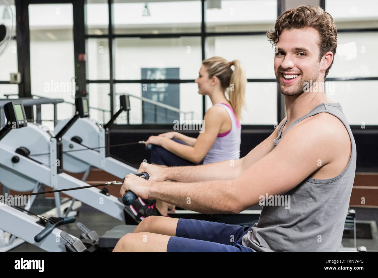 Portrait of man working out on rowing machine Stock Photo - Alamy