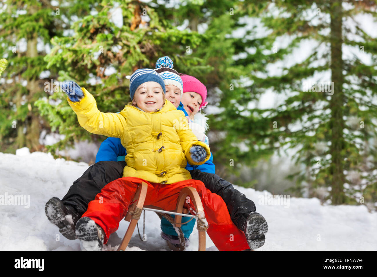 Children winter fun on sledge sliding down Stock Photo - Alamy