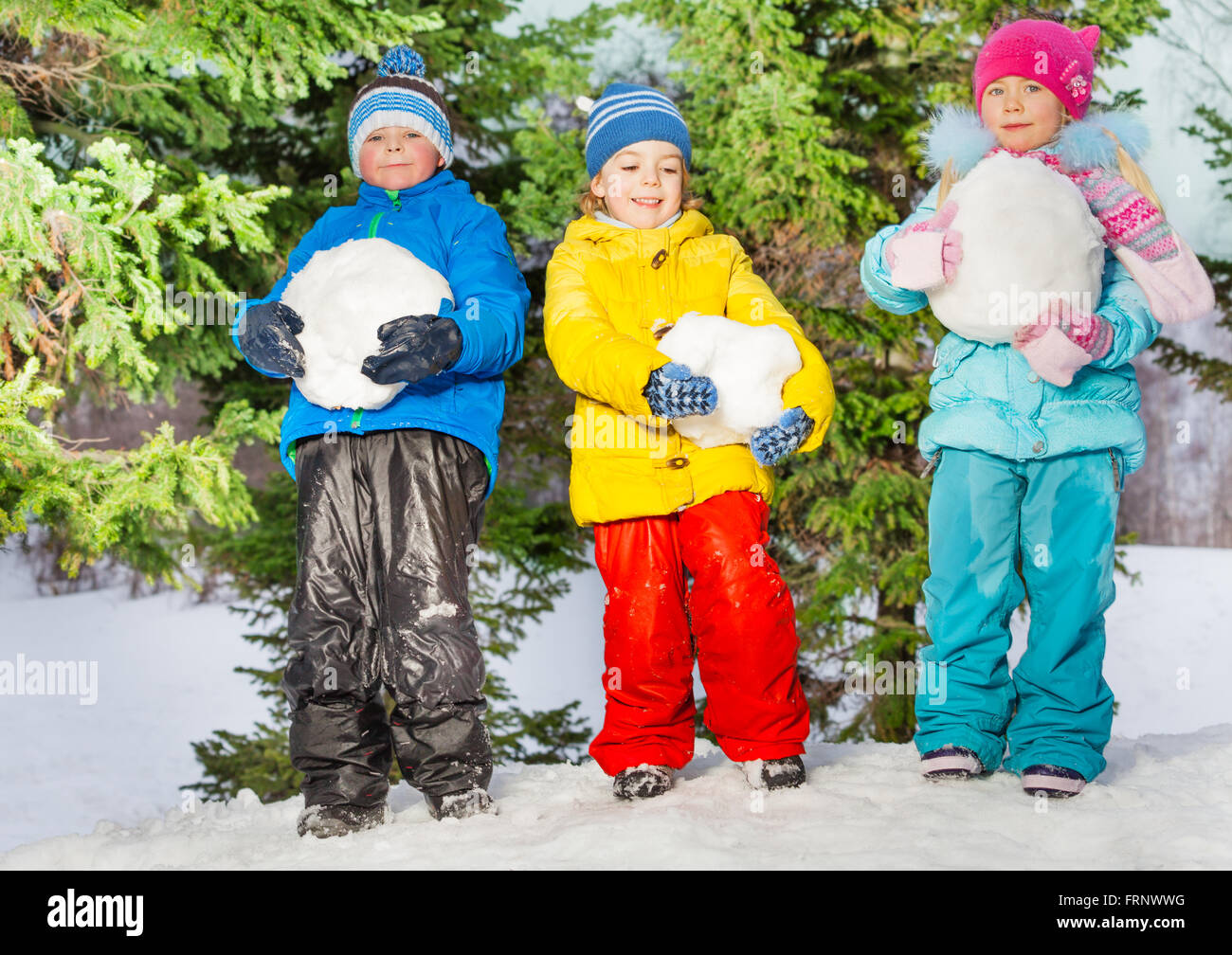 Little kids with big snowballs in the park Stock Photo - Alamy