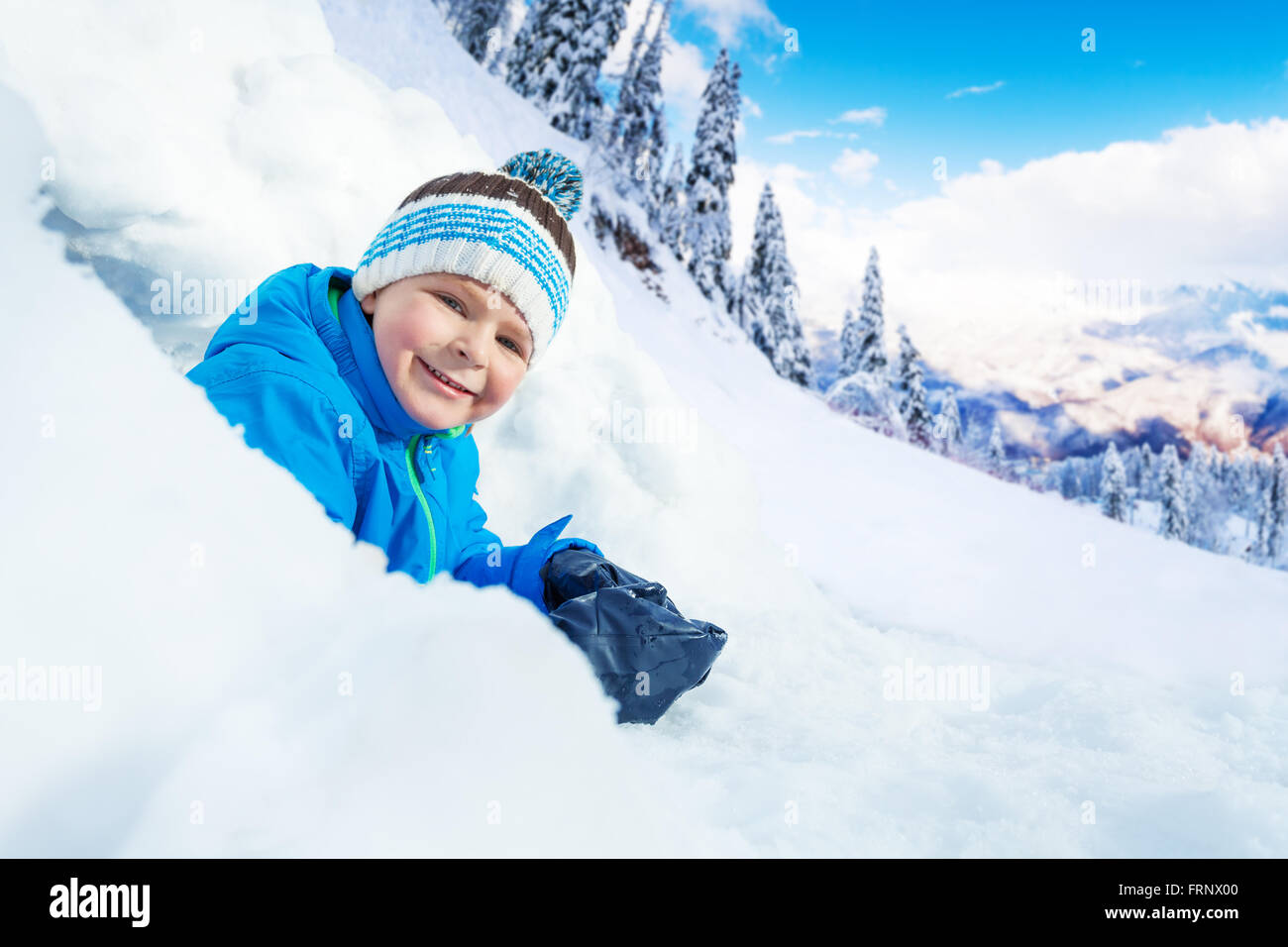 Little boy crawl out of snow cave in park Stock Photo - Alamy