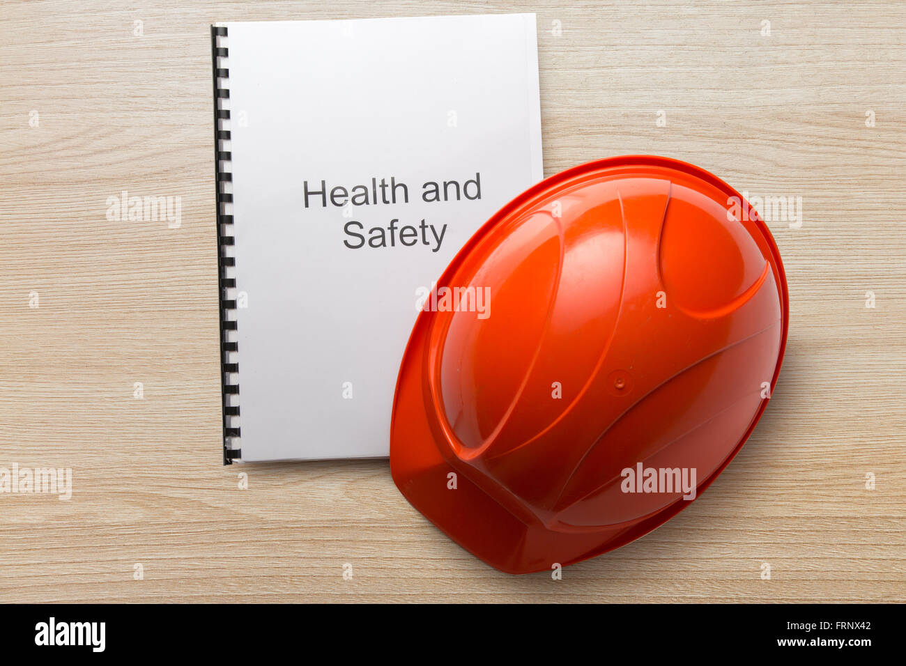 Health and safety register with helmet in closeup Stock Photo - Alamy