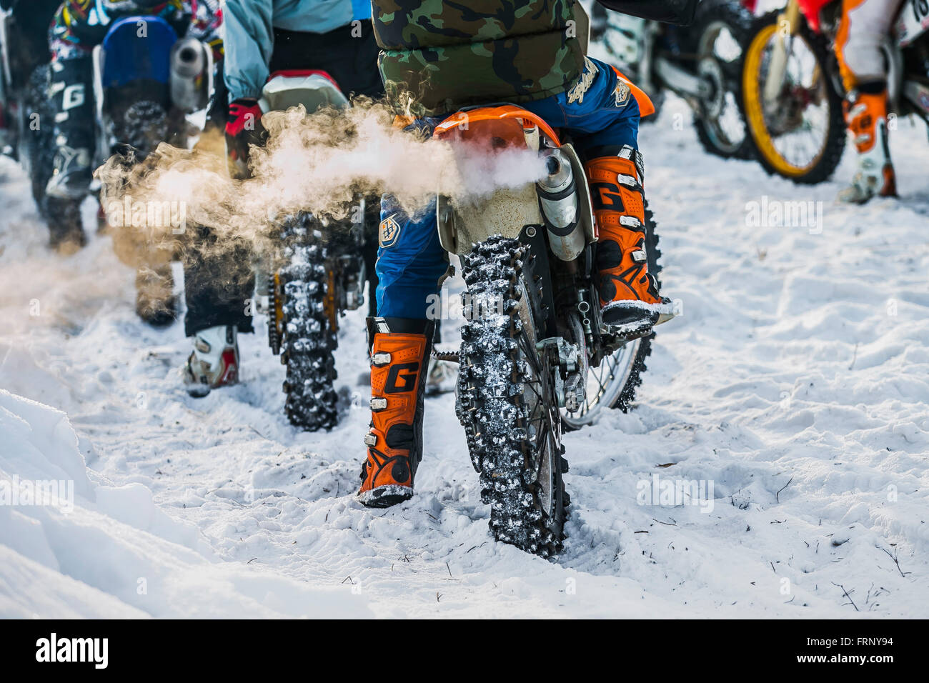 closeup rider on bike preparing for race start, exhaust smoke during ...