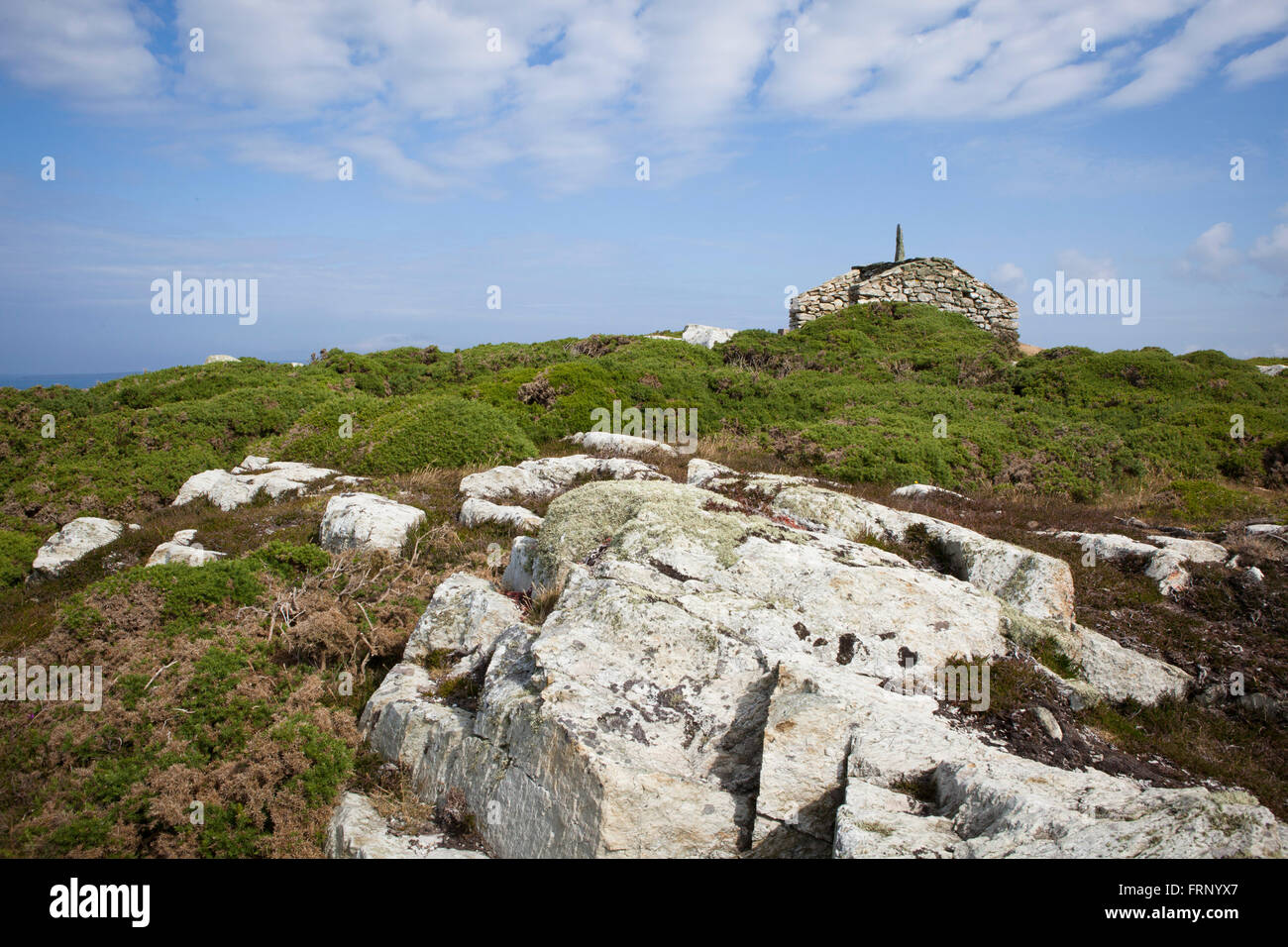 A walker on the coastal path on coast of Anglesey North Wales on a ...