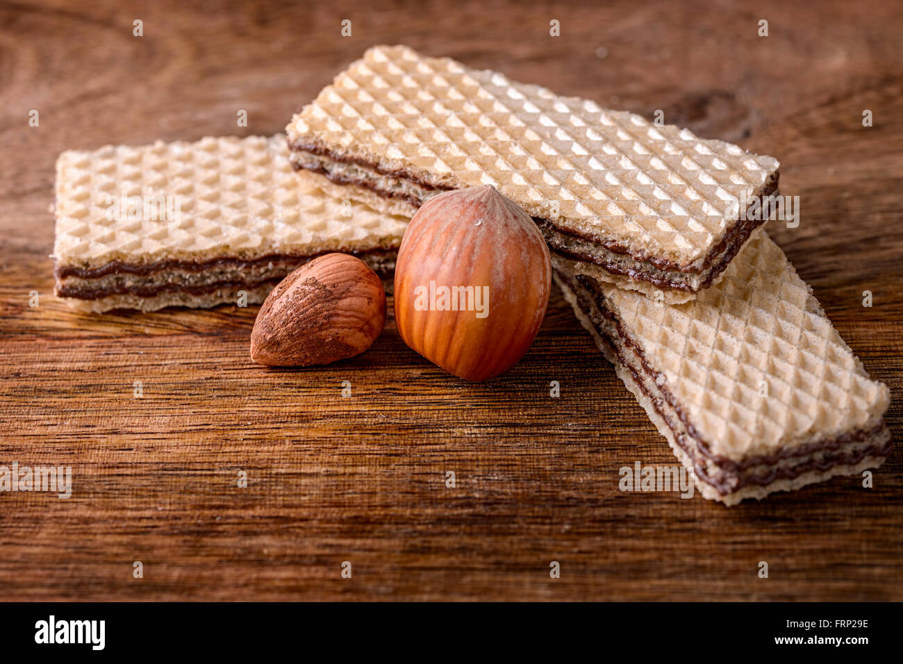 wafer and hazelnut on wood Stock Photo - Alamy