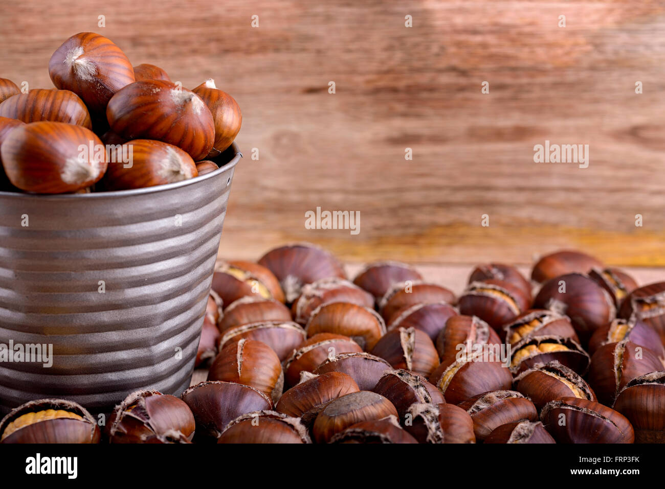 chestnuts in a tin bucket and chestnuts roasted on wood Stock Photo - Alamy