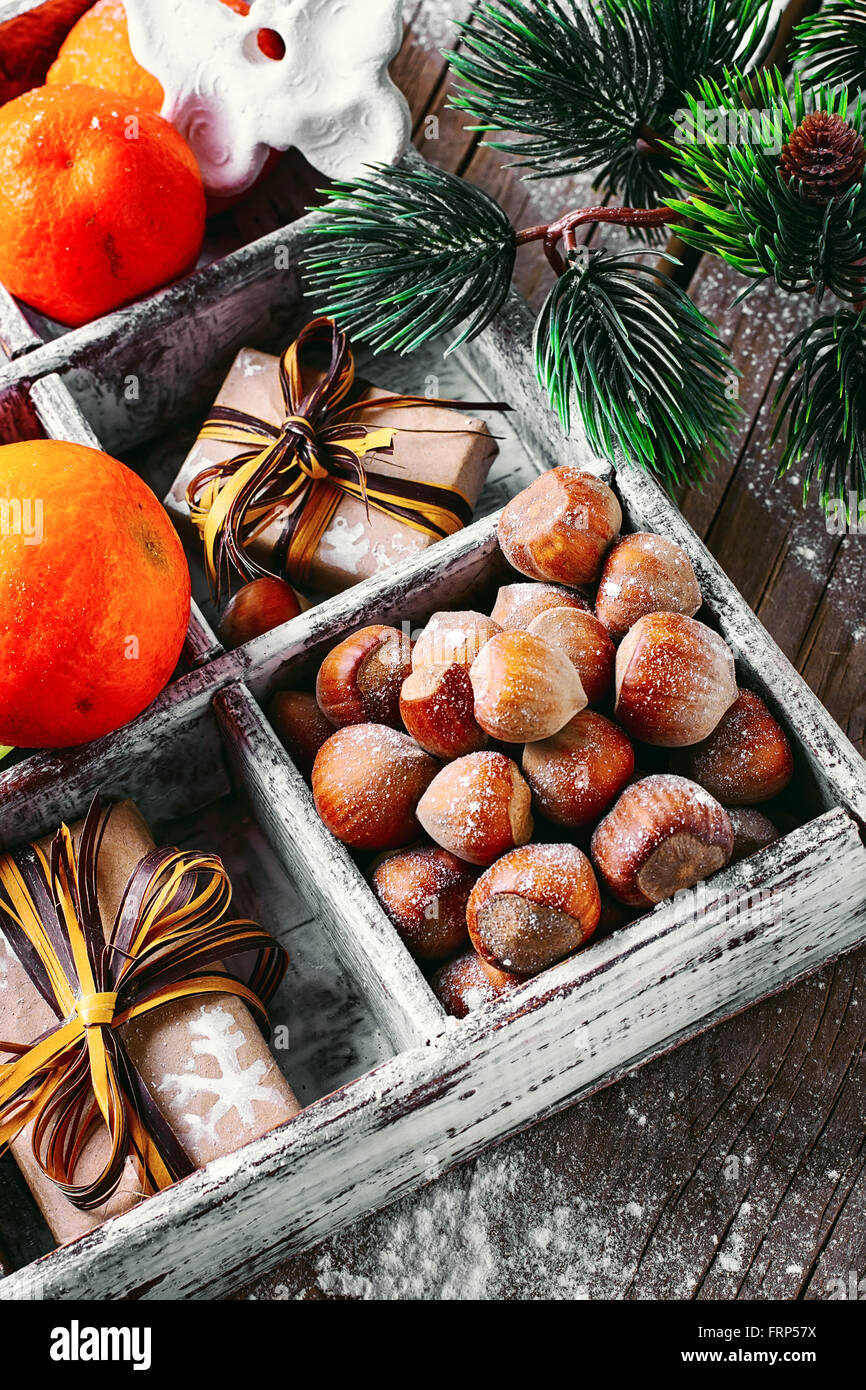 Vintage light box with Mandarin,hazelnuts and packaged gift Stock Photo ...