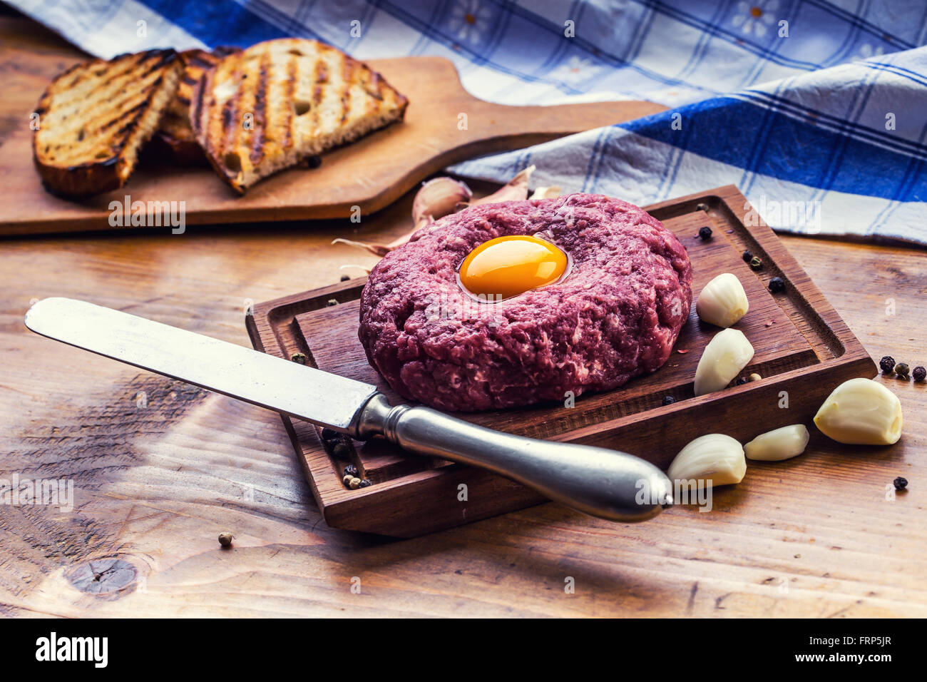 Raw beef .Tasty Steak tartare. Classic steak tartare on wooden board ...