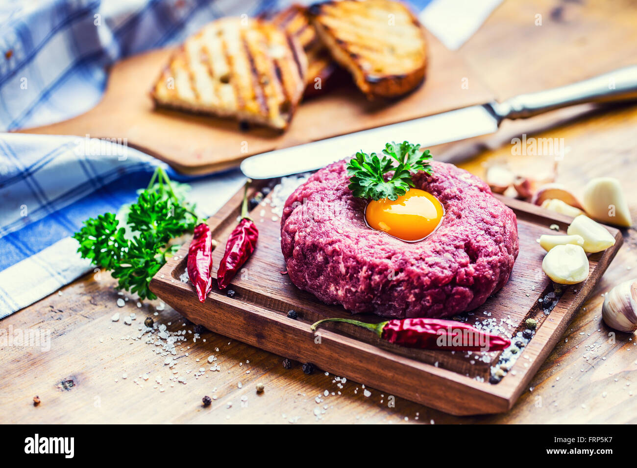 Raw beef .Tasty Steak tartare. Classic steak tartare on wooden board ...