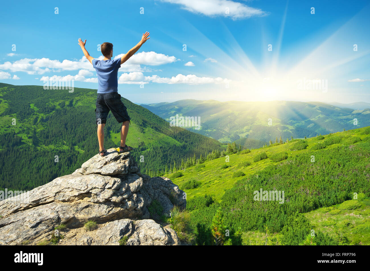 Man on peak of mountain. Emotional scene Stock Photo - Alamy