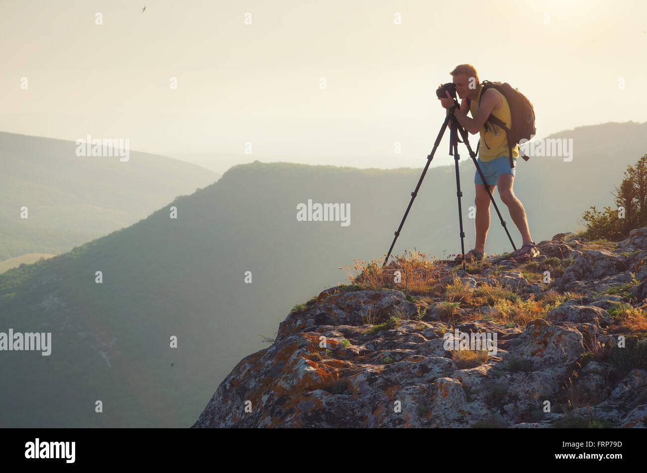 Photograph work in mountain. Job scene Stock Photo - Alamy