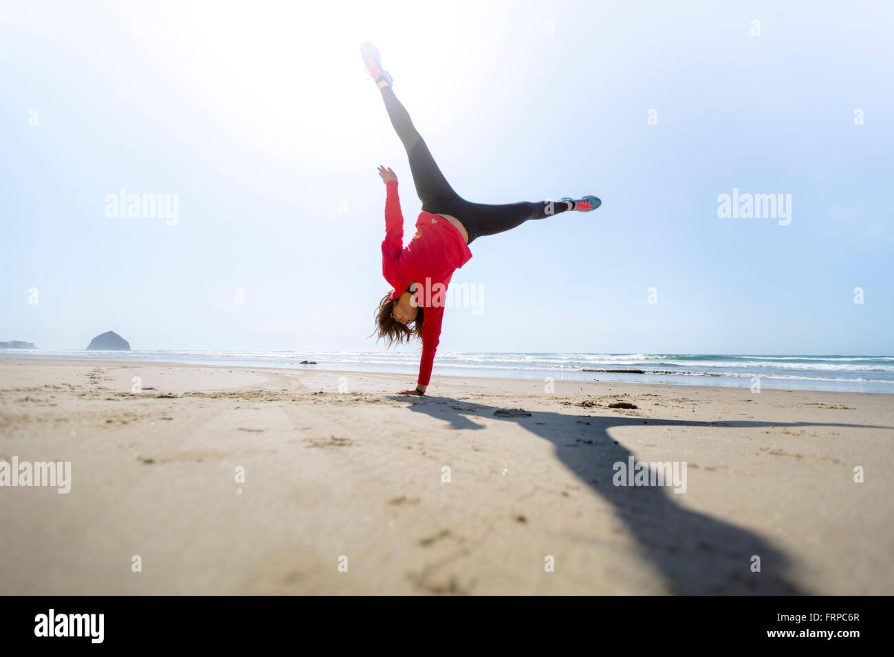 Girl does one handed cartwheel Stock Photo - Alamy