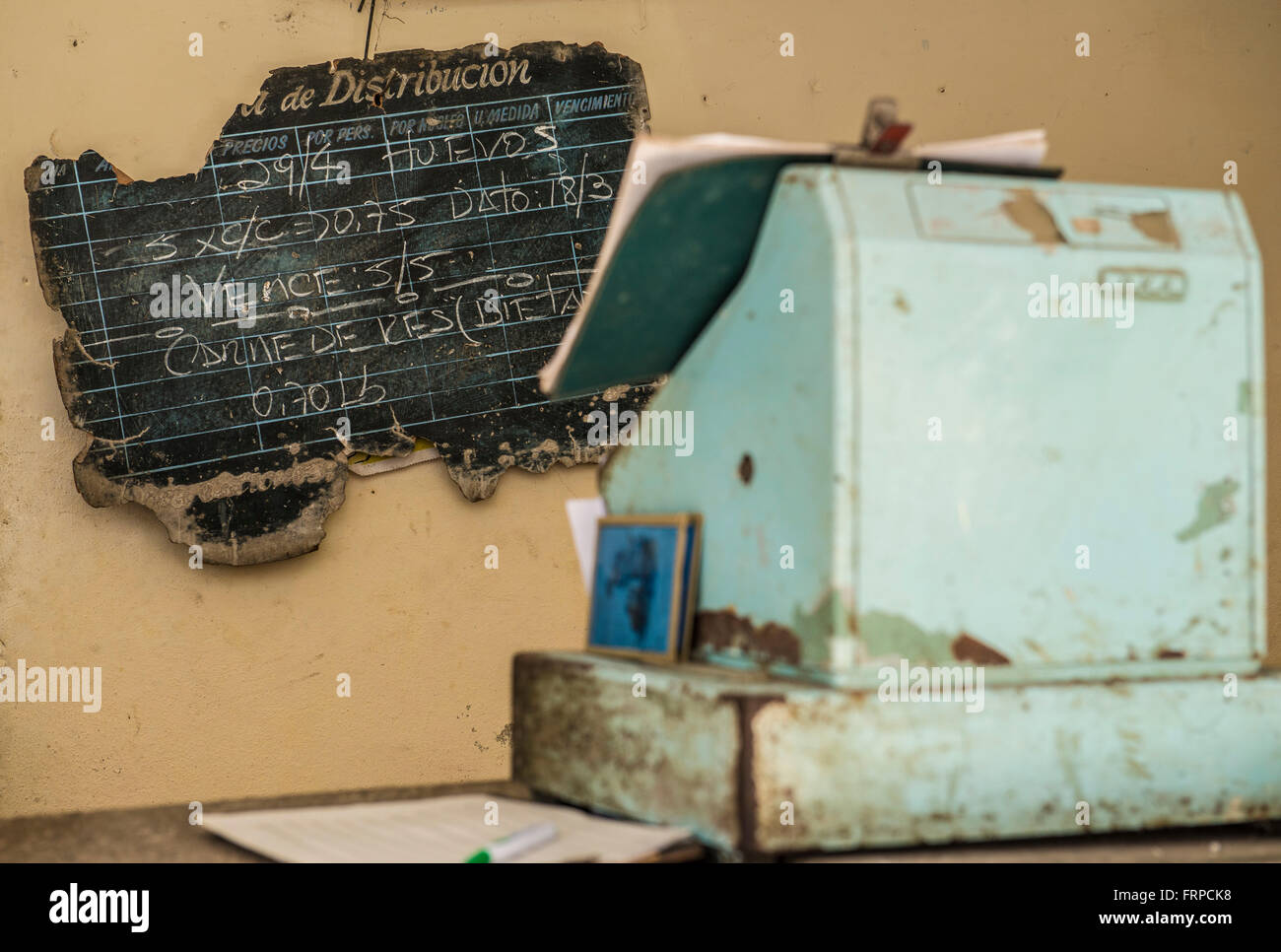 A tattered chalkboard displays prices of meat and eggs in a Cuban ...