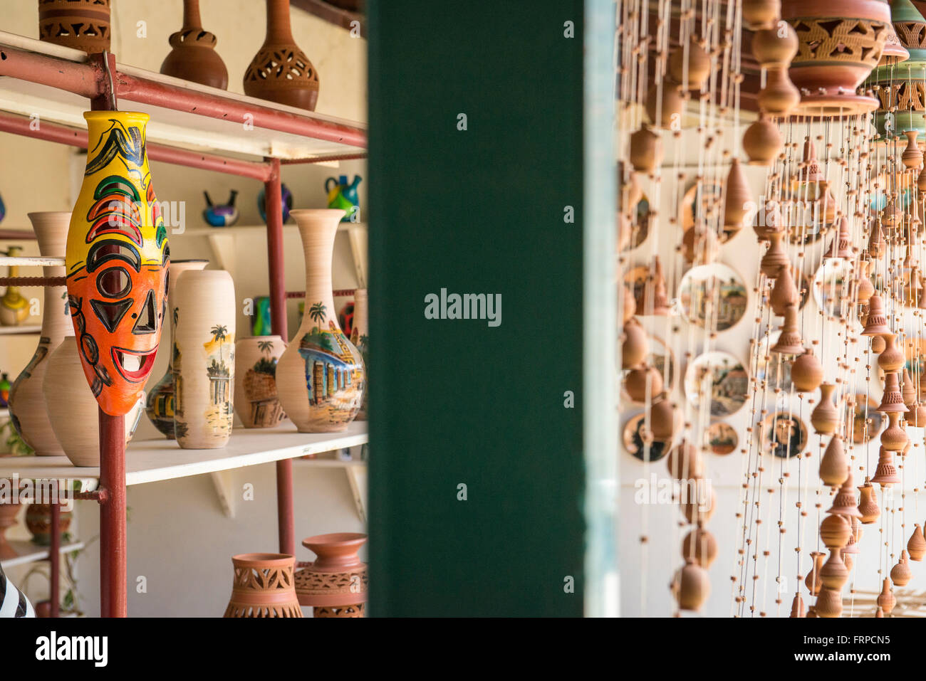 Wind chimes, vases, and a mask on display at the Santander El Alfarero ...