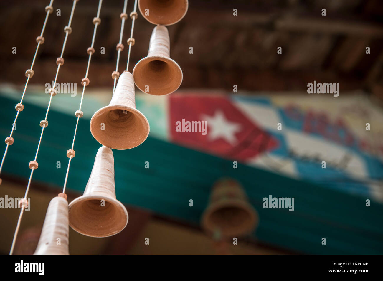 Spiral clay wind chimes hang in El Alfarero Casa Chichi's workshop in ...