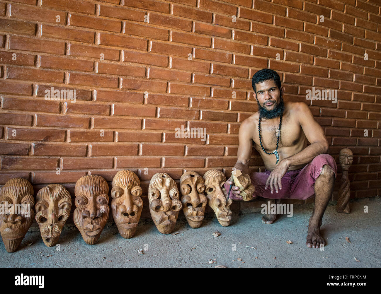 Young Cuban artist displaying his carved decorative masks in his ...