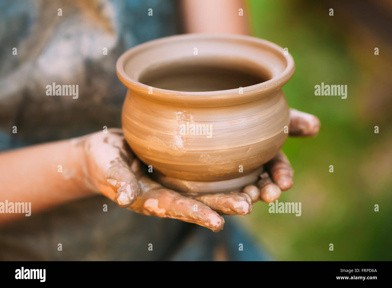 Handmade of clay pot in female hands. Art and successful work ...