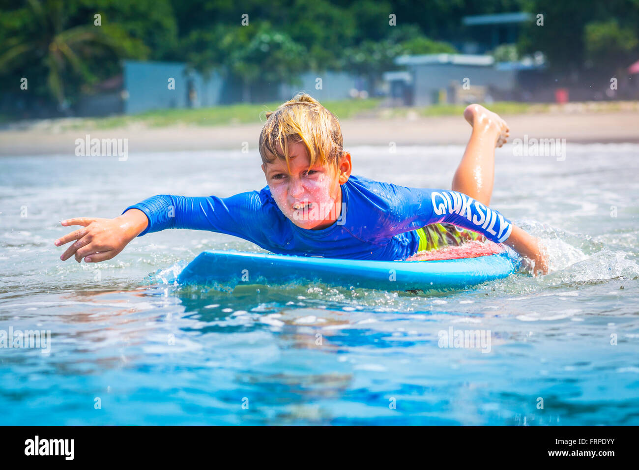 Young surfer, happy young boy in the ocean on surfboard Stock Photo - Alamy