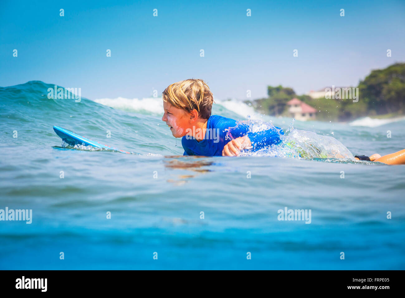 Young surfer, happy young boy in the ocean on surfboard Stock Photo - Alamy