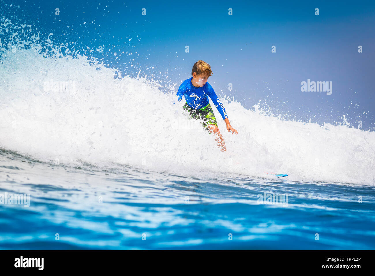 Young surfer, happy young boy in the ocean on surfboard Stock Photo - Alamy