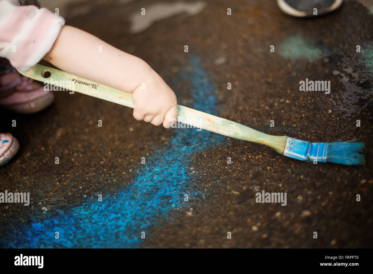 Children painting on the ground Stock Photo - Alamy