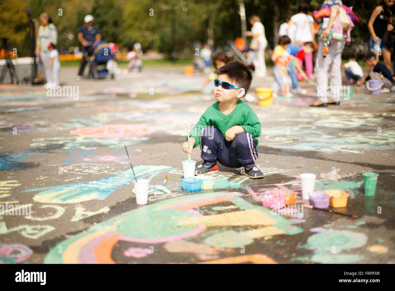 Children painting on the ground Stock Photo - Alamy