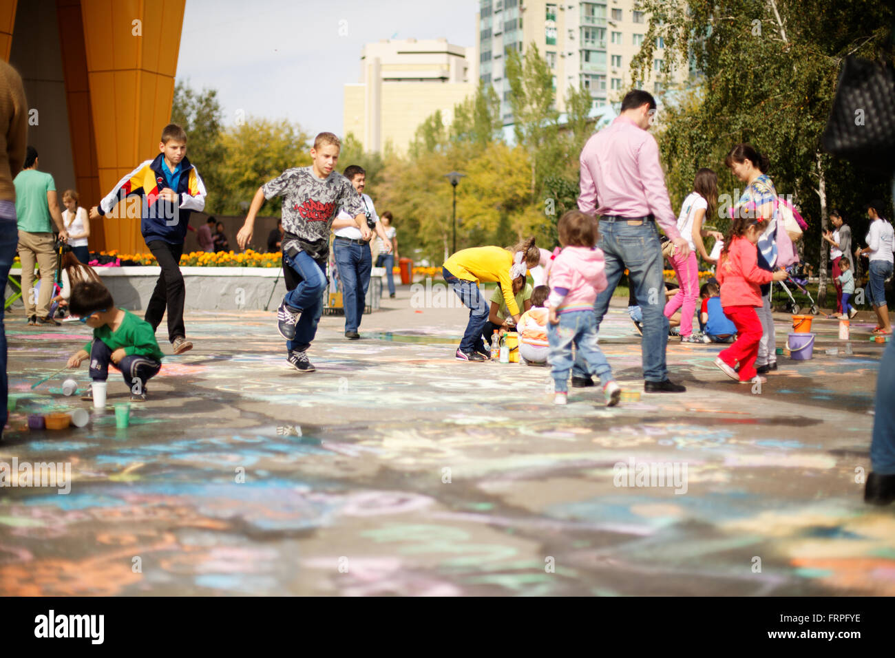 Children painting on the ground Stock Photo - Alamy